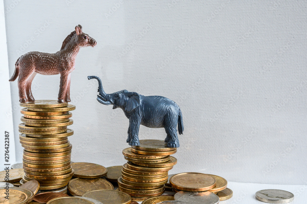 Elephant and donkey on top of stacked coins Stock Photo | Adobe Stock