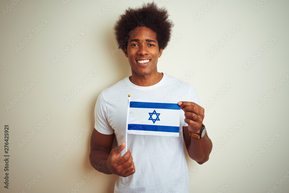 Young african american man holding Israel Israeli flag standing over ...