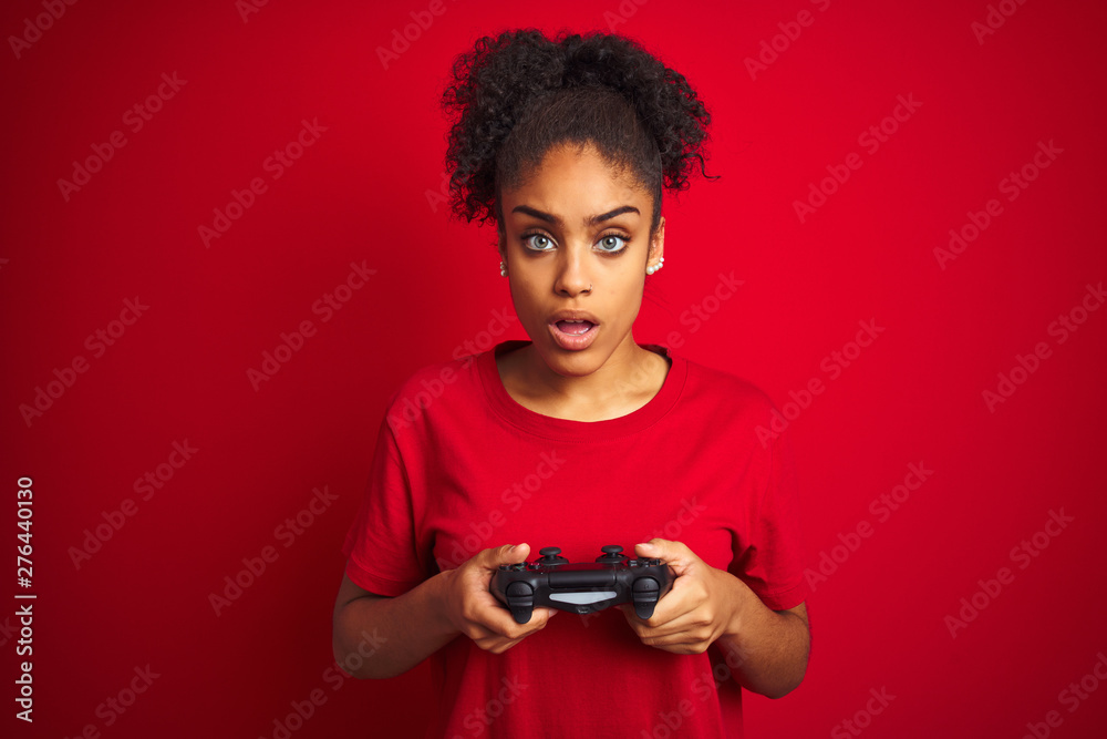 African american gamer woman playing video game using joystick over ...