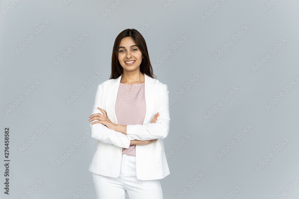 Smiling indian young businesswoman wear white suit looking at camera ...