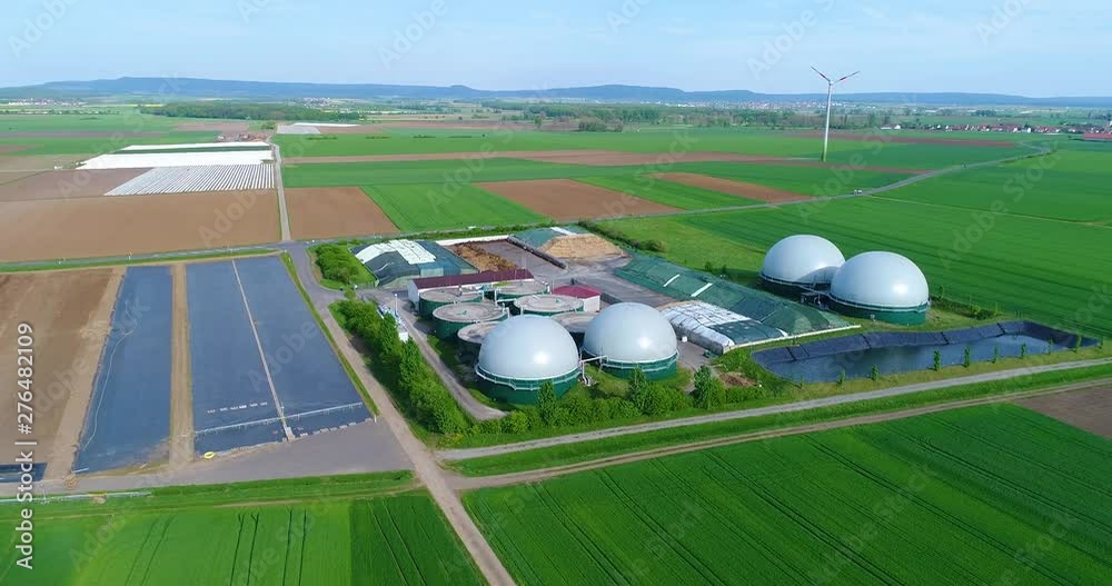 Camera flight over biogas plant from pig farm. Renewable energy from ...