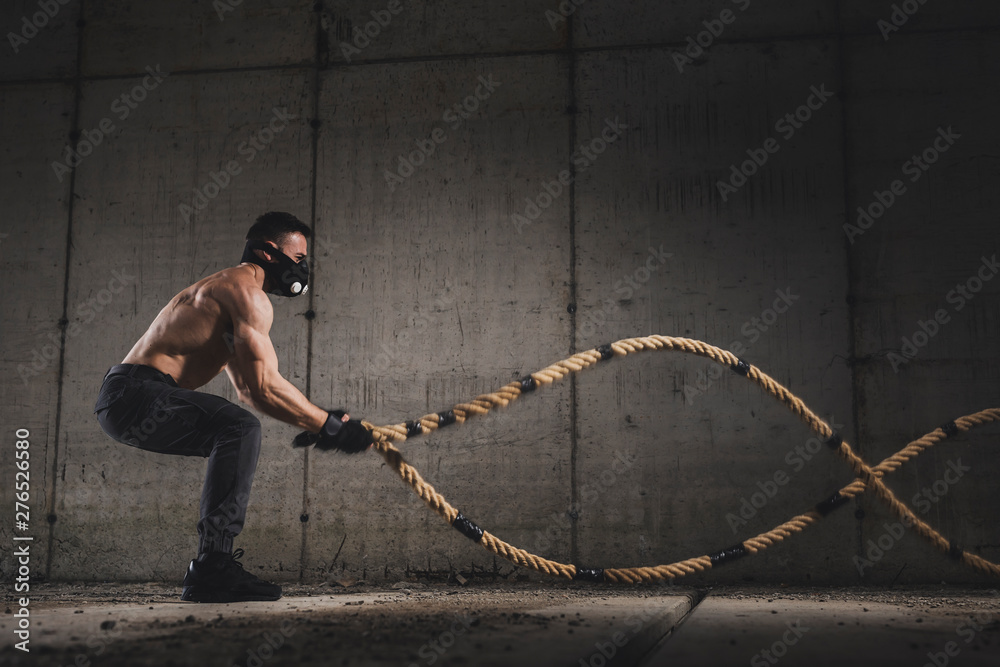 Athlete doing a battle ropes training Stock Photo | Adobe Stock