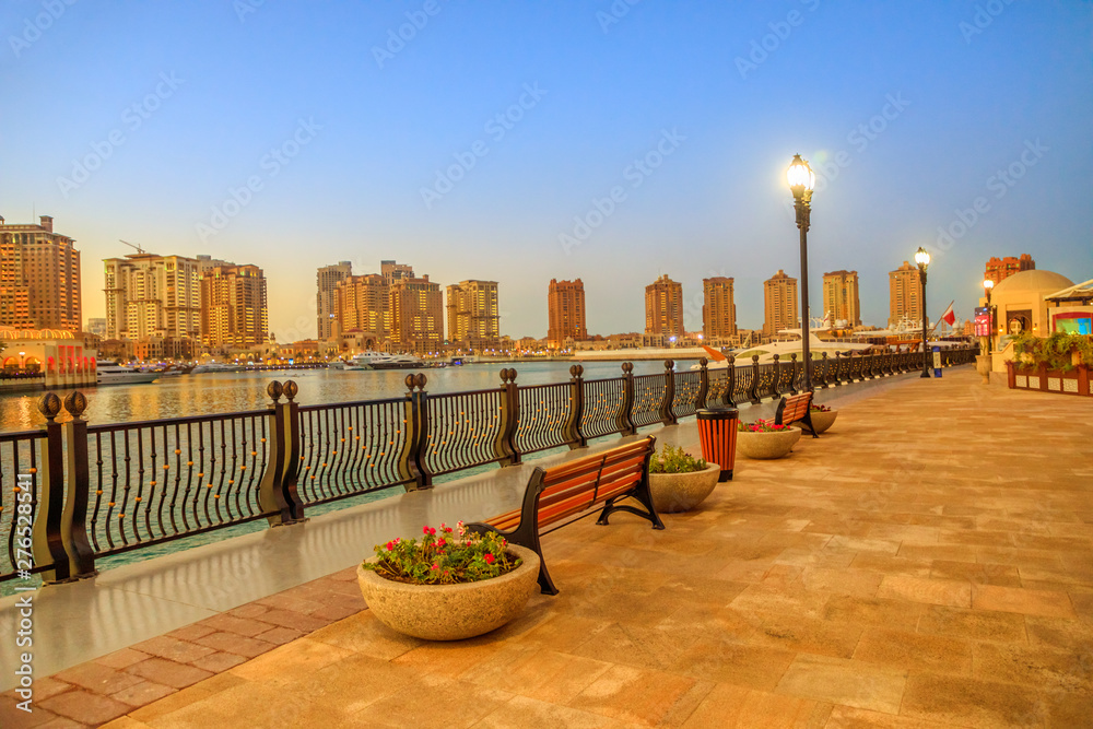 Benches along marina corniche walkway in Porto Arabia at the Pearl ...