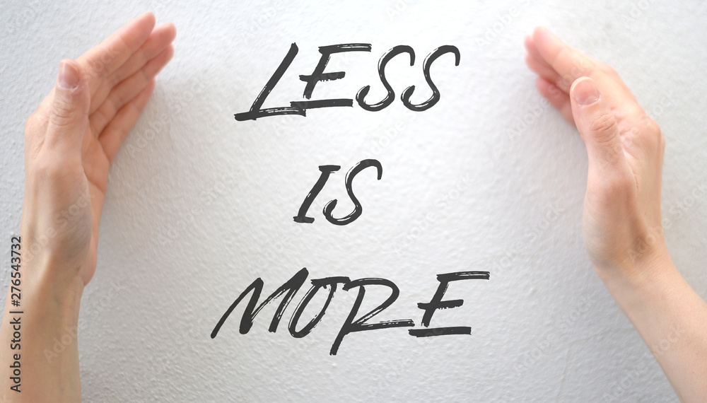 Hands holding the words Less is more, minimalism motto. Concept of ...