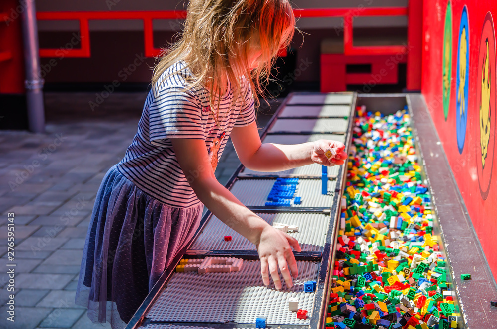 Cute girl builds out lego cubes Stock Photo | Adobe Stock