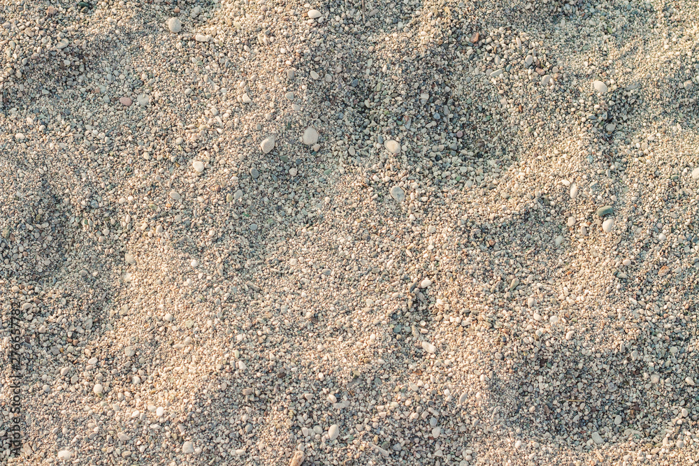 Beach sand. The texture of small stones and sand. Can be used as a ...