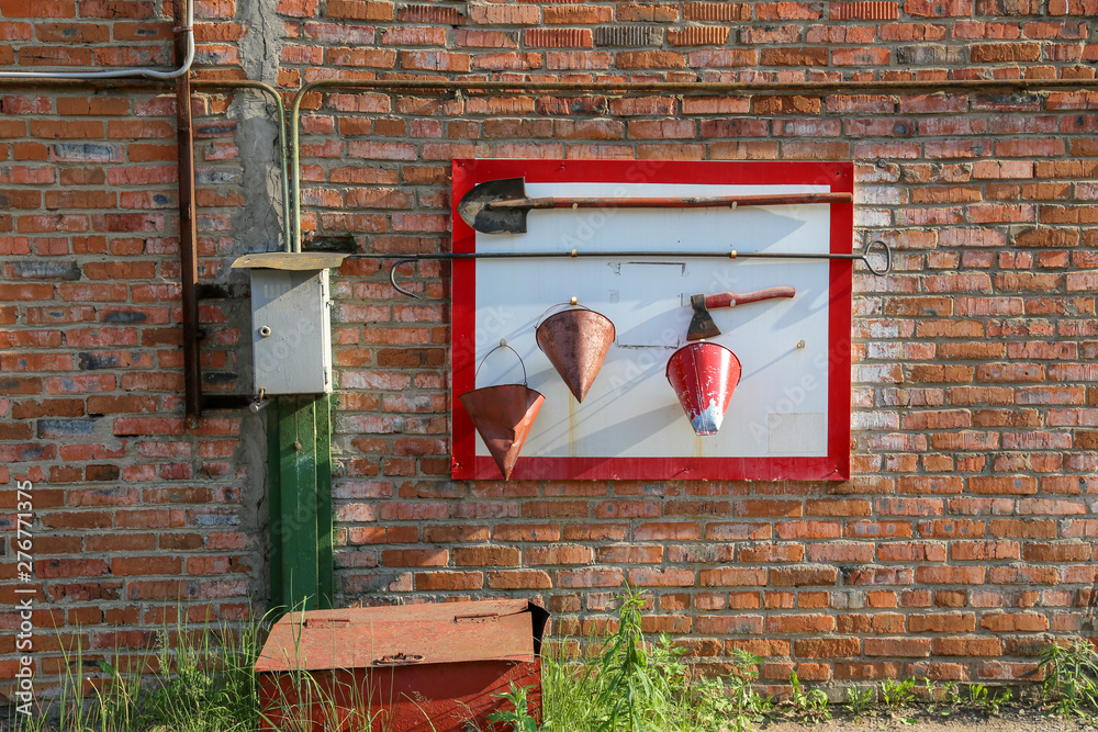 Fire safety, white shield of fire safety. Brick wall with a fire shield ...