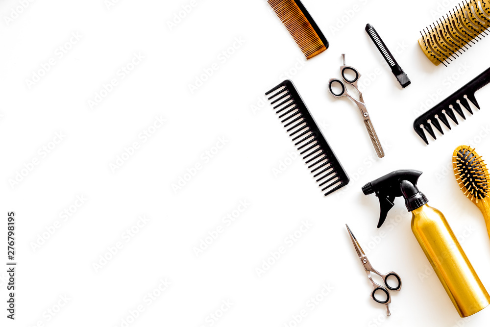 Combs, spray and hairdresser tools in beauty salon work desk on white ...