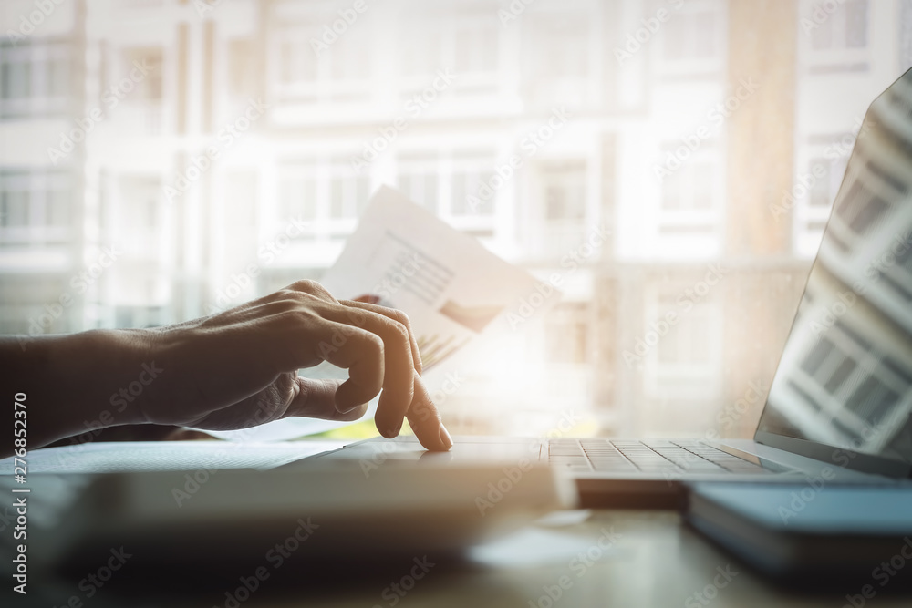 Business man using calculator to review balance sheet annual with using ...