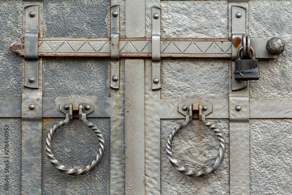 antique forged metal doors with rings and a heavy bolt Stock Photo ...