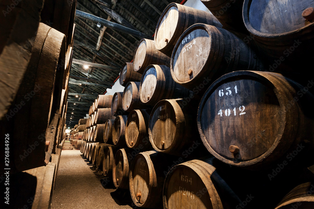 Photo & Art Print Dark wine cellar with numbered wooden barrels for ...