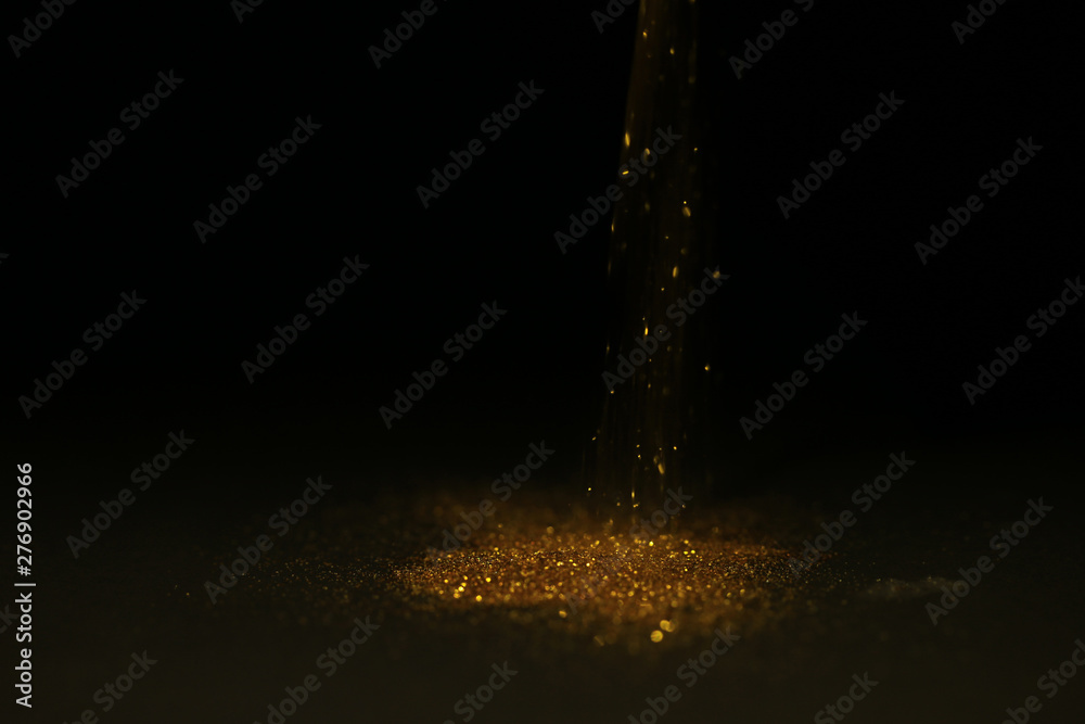 Abstract background of Sprinkle gold dust with glitter lights on black ...