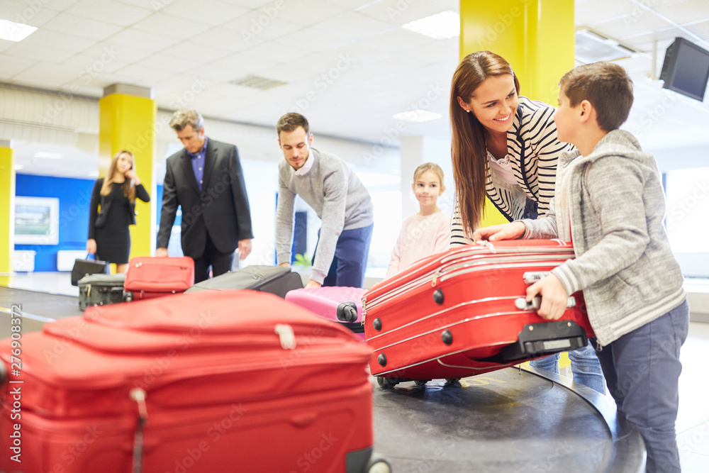 Family and other passengers pick up their bags Stock Photo | Adobe Stock