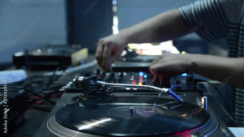 DJ working playing music with his equipment on festival. Professional ...