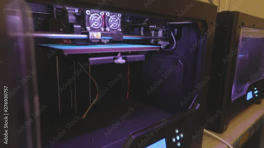 3D printer working. 3D printer printing an object from plastic ...