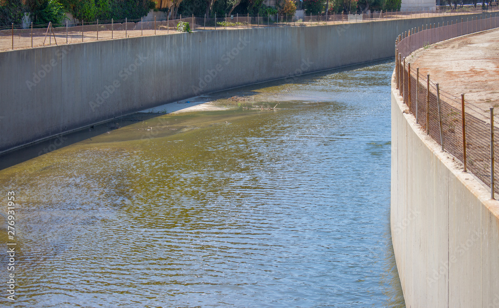 polluted river water flowing through a curved cement channel in Los ...