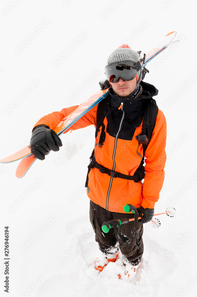 Portrait of a professional skier athlete in a knitted hat and orange ...