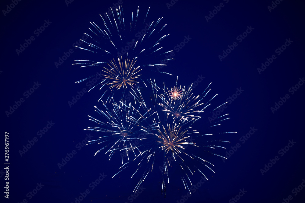 Cheap bright sparkling fireworks, blue and golden color, on the night ...