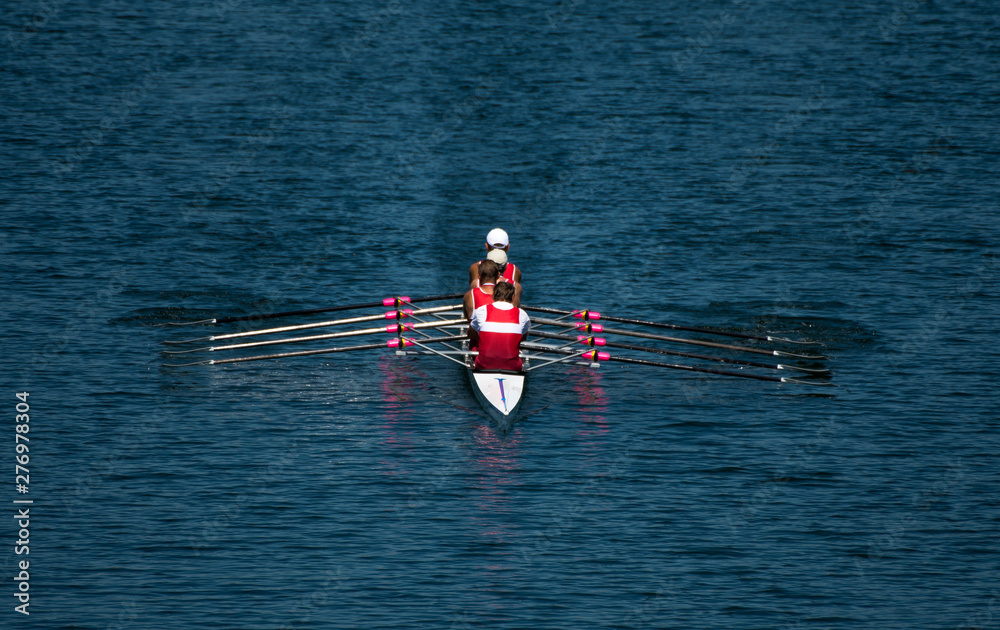 Foto de Four Male Rowers In A Quad Racing Boat With Synchronous Oar ...