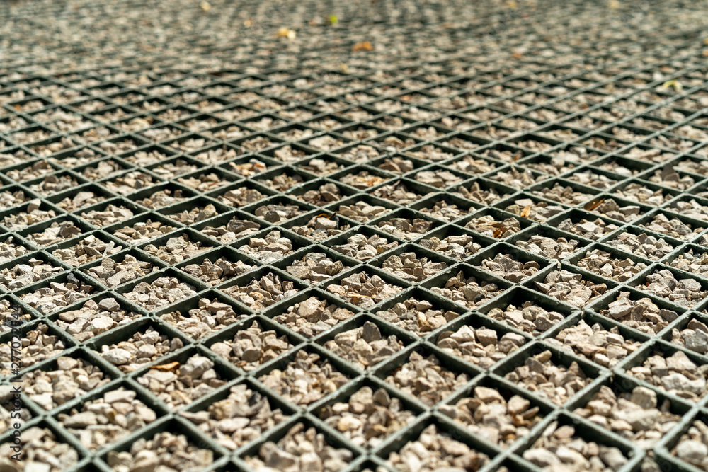 special pavement of metal mesh and small gravel for arranging parking ...