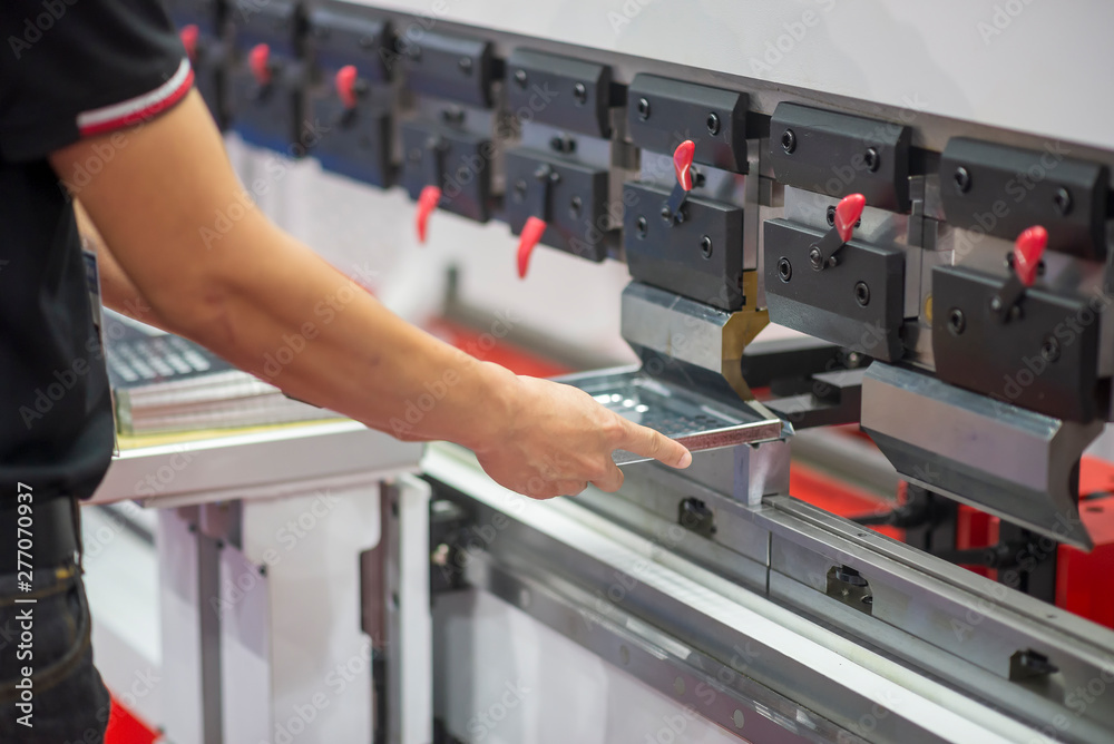 The sheet metal process by bending machine. The skill operator working ...