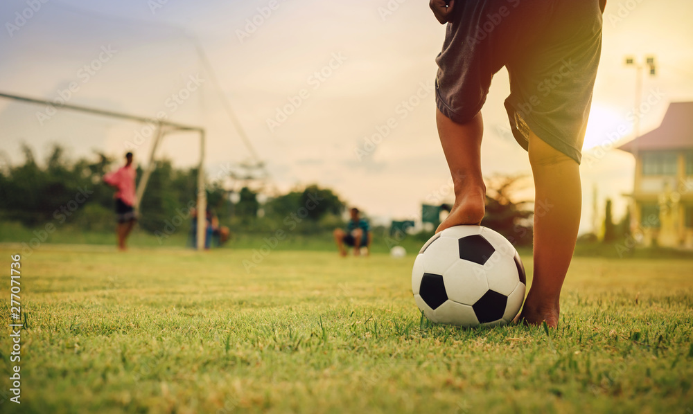 Action sport outdoors of kids having fun playing soccer football for ...