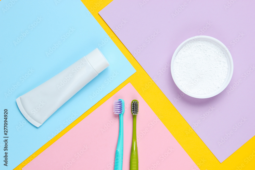 Minimalistic oral hygiene concept. Two toothbrushes with a tube of ...