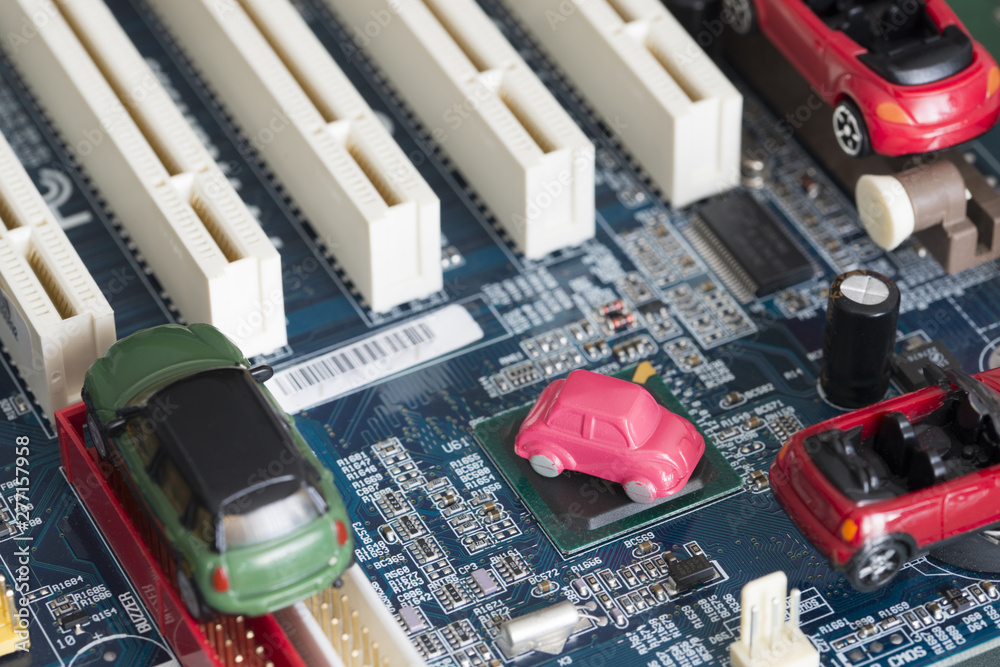 Miniature cars on computer motherboard, smart car concept Stock Photo ...