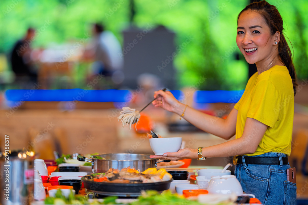 A young beautiful asian girl Enjoy eating shabu shabu with relaxing ...