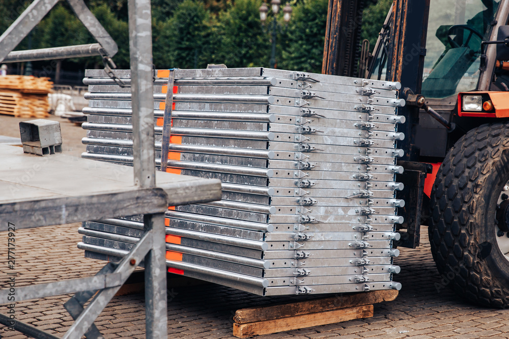 Forklift delivers metal profile from warehouse for construction of ...