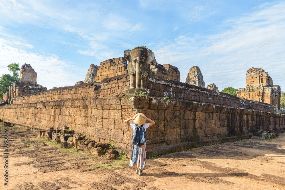 One tourist visiting Angkor Wat ruins at sunrise, Pre Rup temple ...