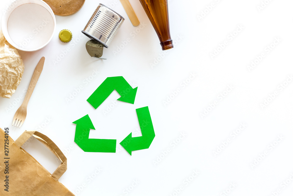 Green recycling sign with waste materials, bottles, cups, paper bag on ...
