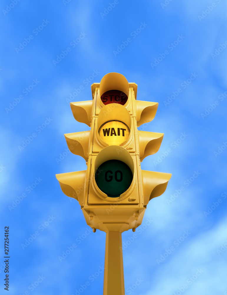 Vintage traffic light with yellow WAIT light on blue sky background ...