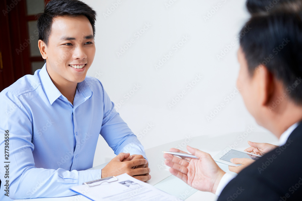 Portrait of young smiling Asian man attending job interview Stock Photo ...