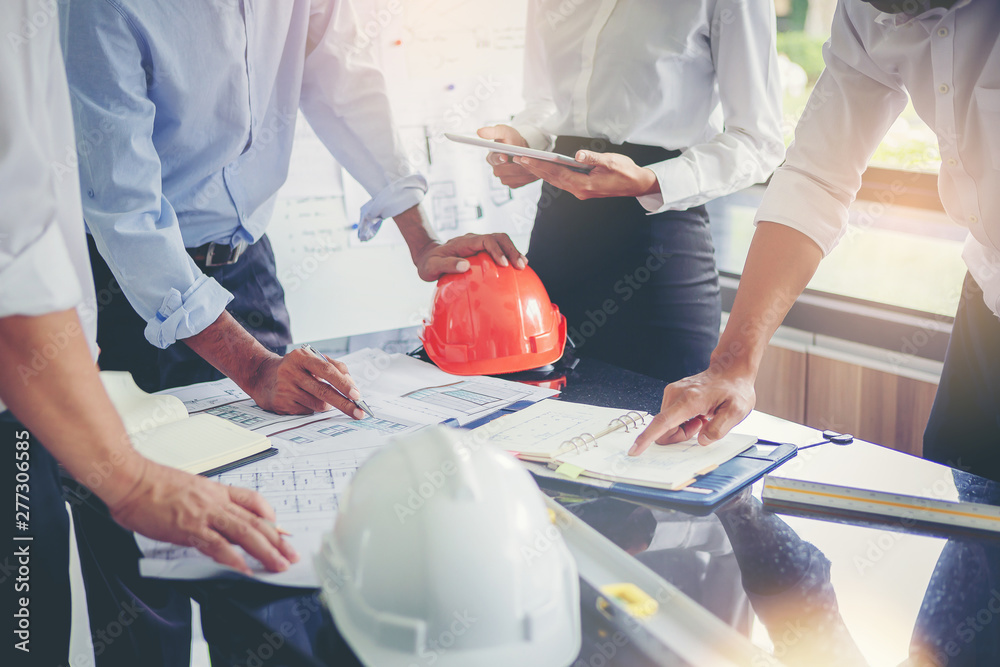 contractor and engineer with blueprints discuss at a modern ...