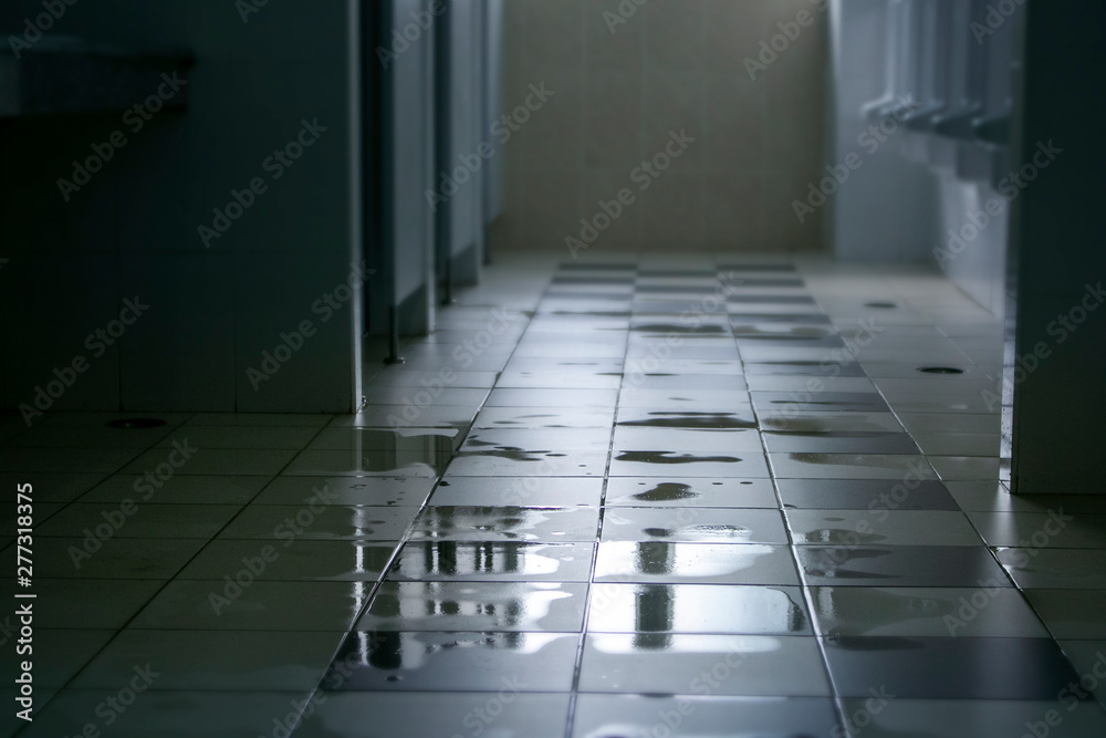 Spilled water leak on the floor of building. Wet floor from rainy ...
