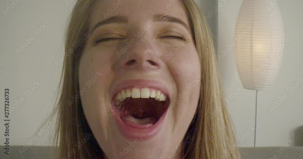 Closeup shoot of young pretty caucasian female opening her mouth and ...