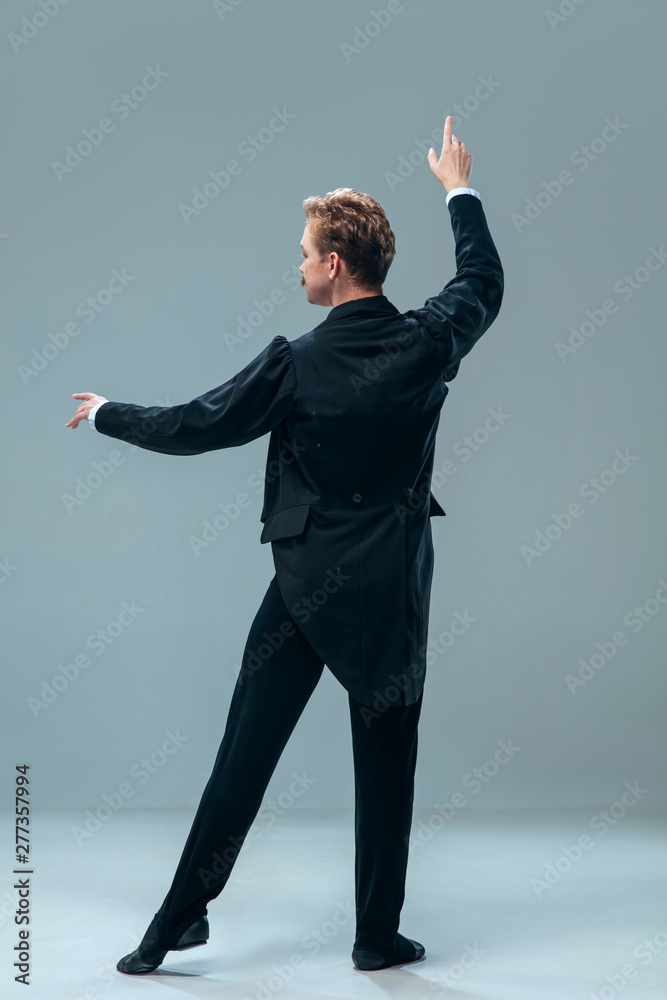 Just a moment. Beautiful contemporary ballroom dancer isolated on grey ...