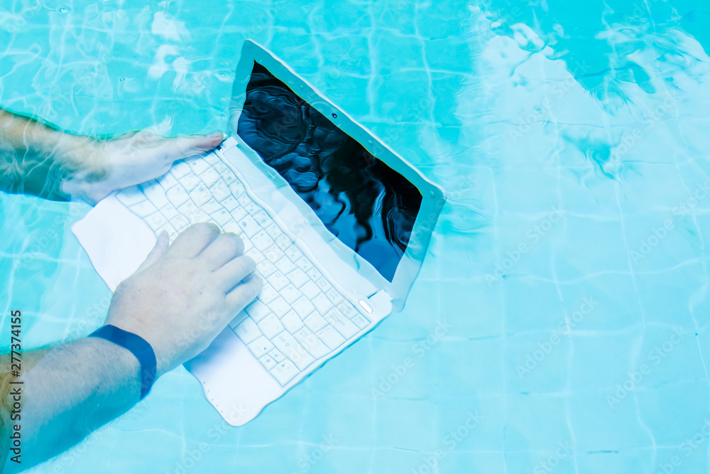 Male works on minicomputer under water. Minicomputer at the bottom of ...