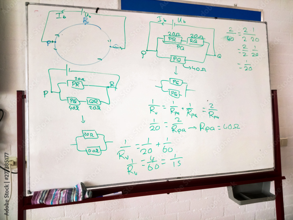White board with schematic drawing and formulas of an electric circuit ...