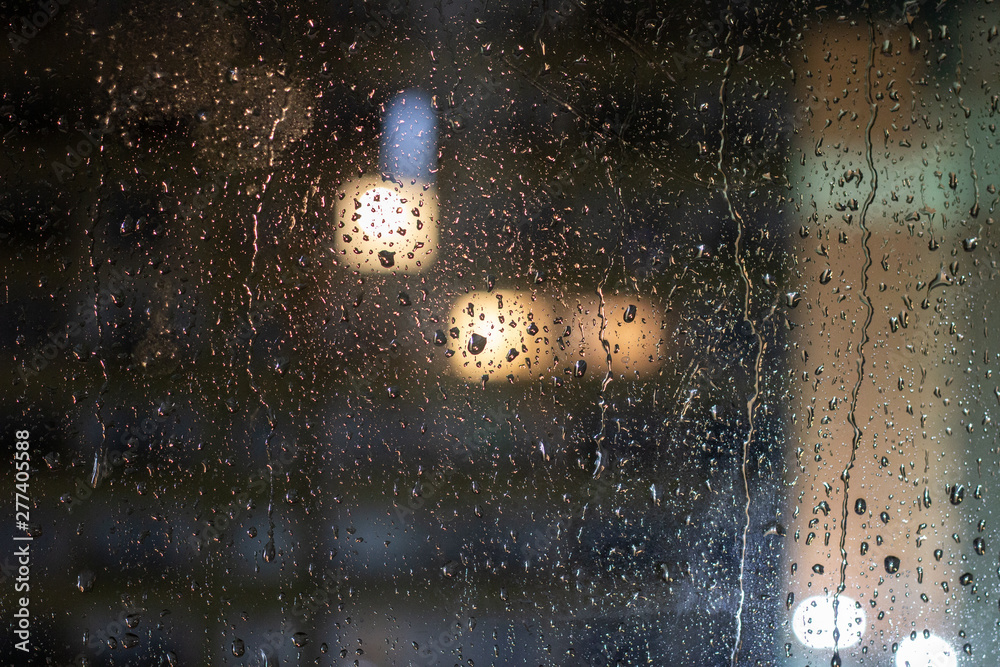 Rain drops. Rain drops on glass on a dark background. Rain drops on the ...
