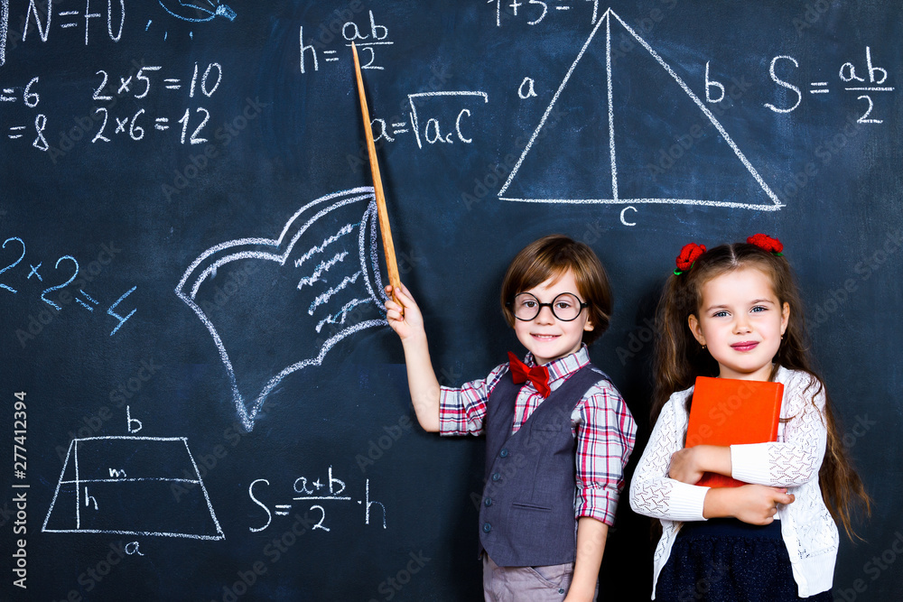 Intelligent smart happy schoolboy and schoolgirl playing in mathematic ...