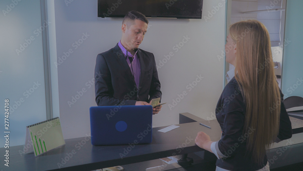 Woman client cash a check in bank. Professional smiling worker giving ...