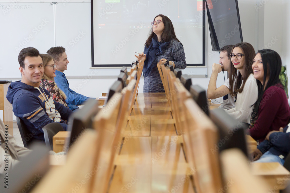 Female professor explain lesson to students and interact with them in ...