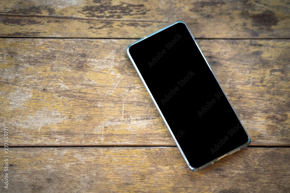 Smartphone or mobile phone (unrecognized model or brand) is placed on ...