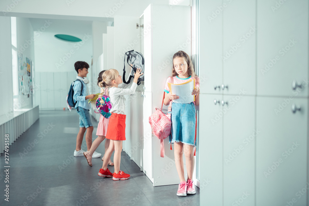 Children using their school lockers while having break from lesson ...