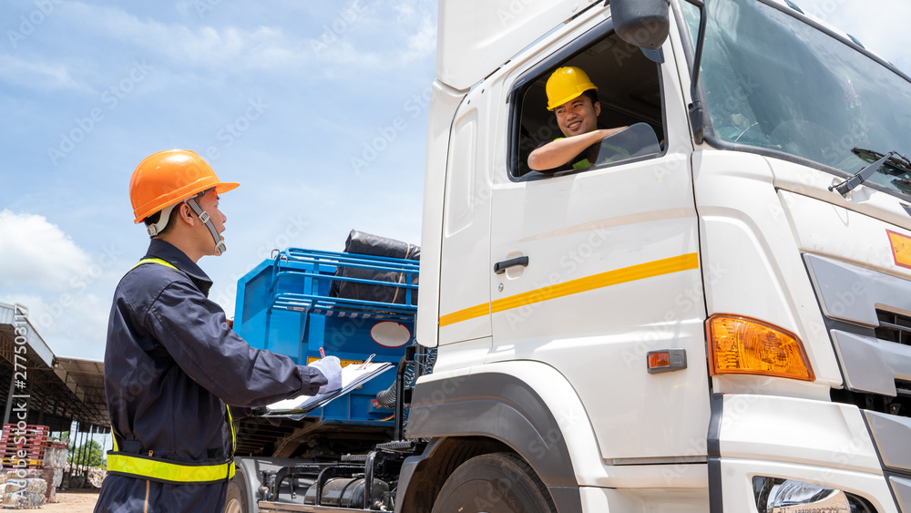 Foreman with safety hats and safety vest is carrying a car inspection ...