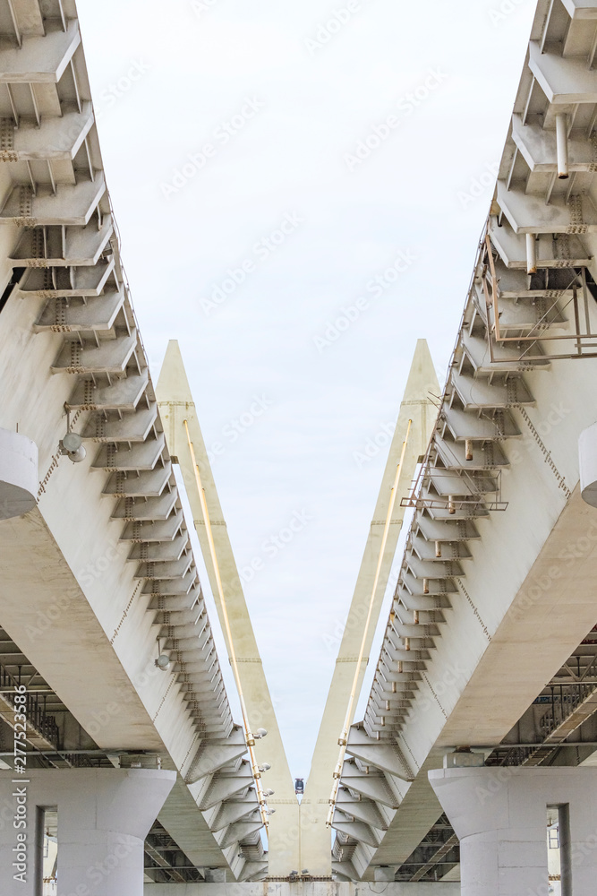 A double concrete bridge photographed from below on sky background ...