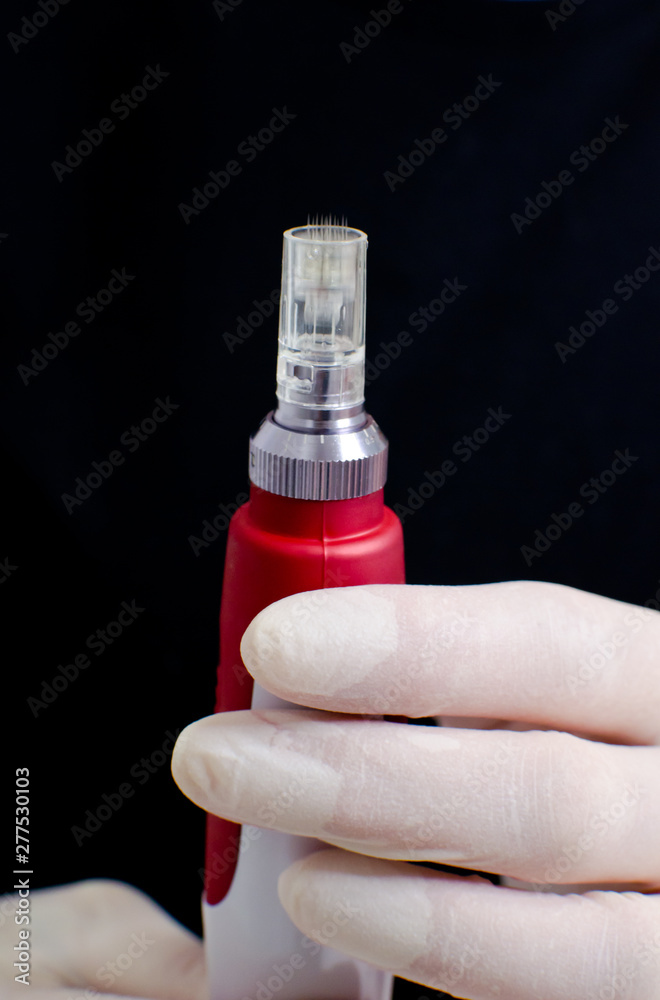 beautician in white gloves holding dermis stamp electric pen, dermapen ...