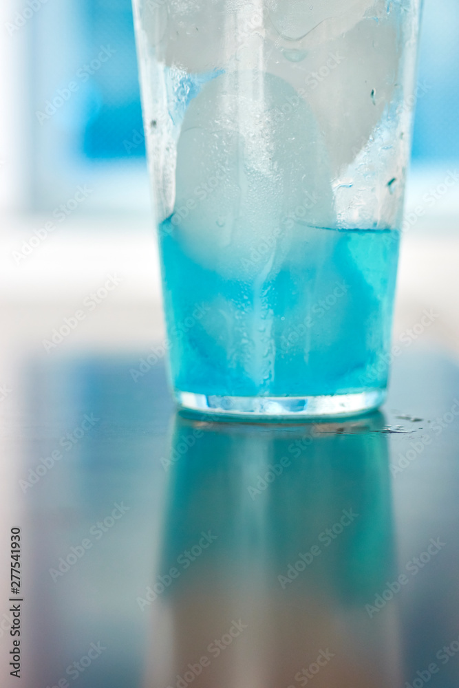 Generic blue berry syrup cocktail image. Close-up view water drops ...